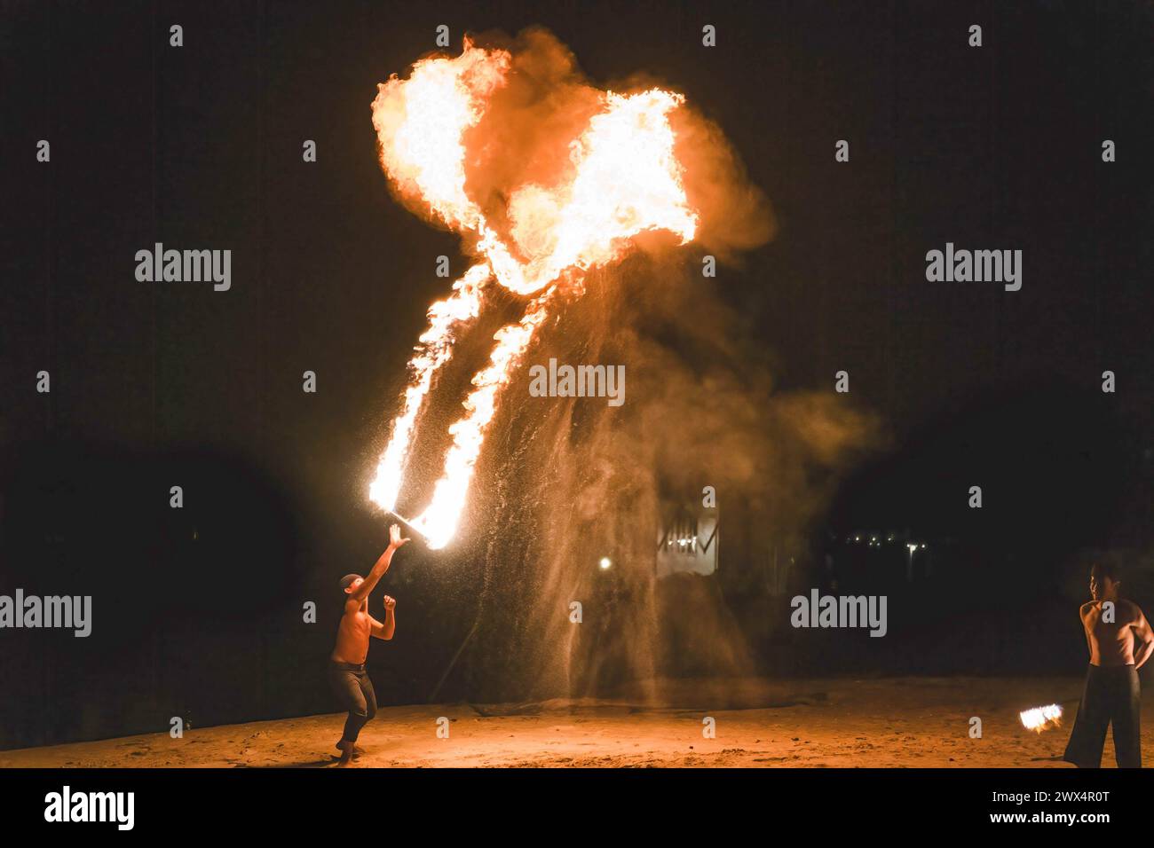 Koh Chang, Thailand. 03rd Jan, 2024. A fire dancer spits fire high in ...