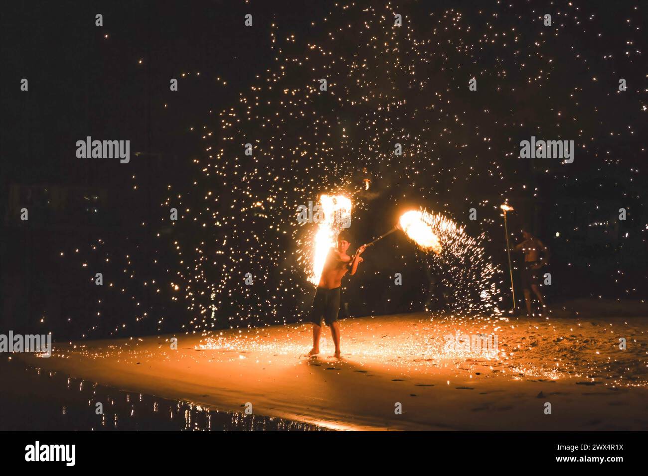 Koh Chang, Thailand. 03rd Jan, 2024. A fire dancer juggles with a fire ...