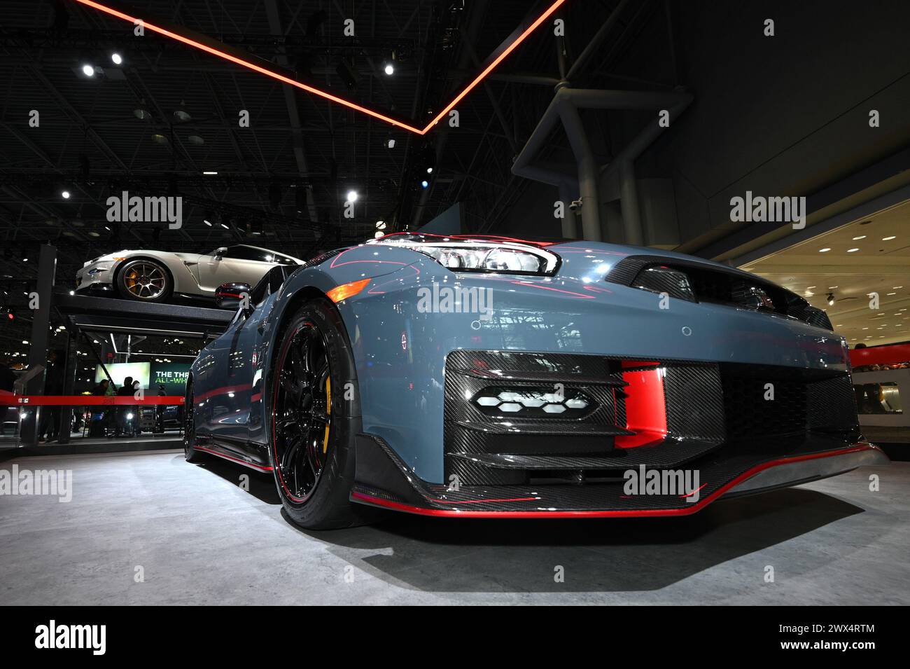 New York, USA. 27th Mar, 2024. A 2024 Nissan GTR Nismo (foreground) and ...