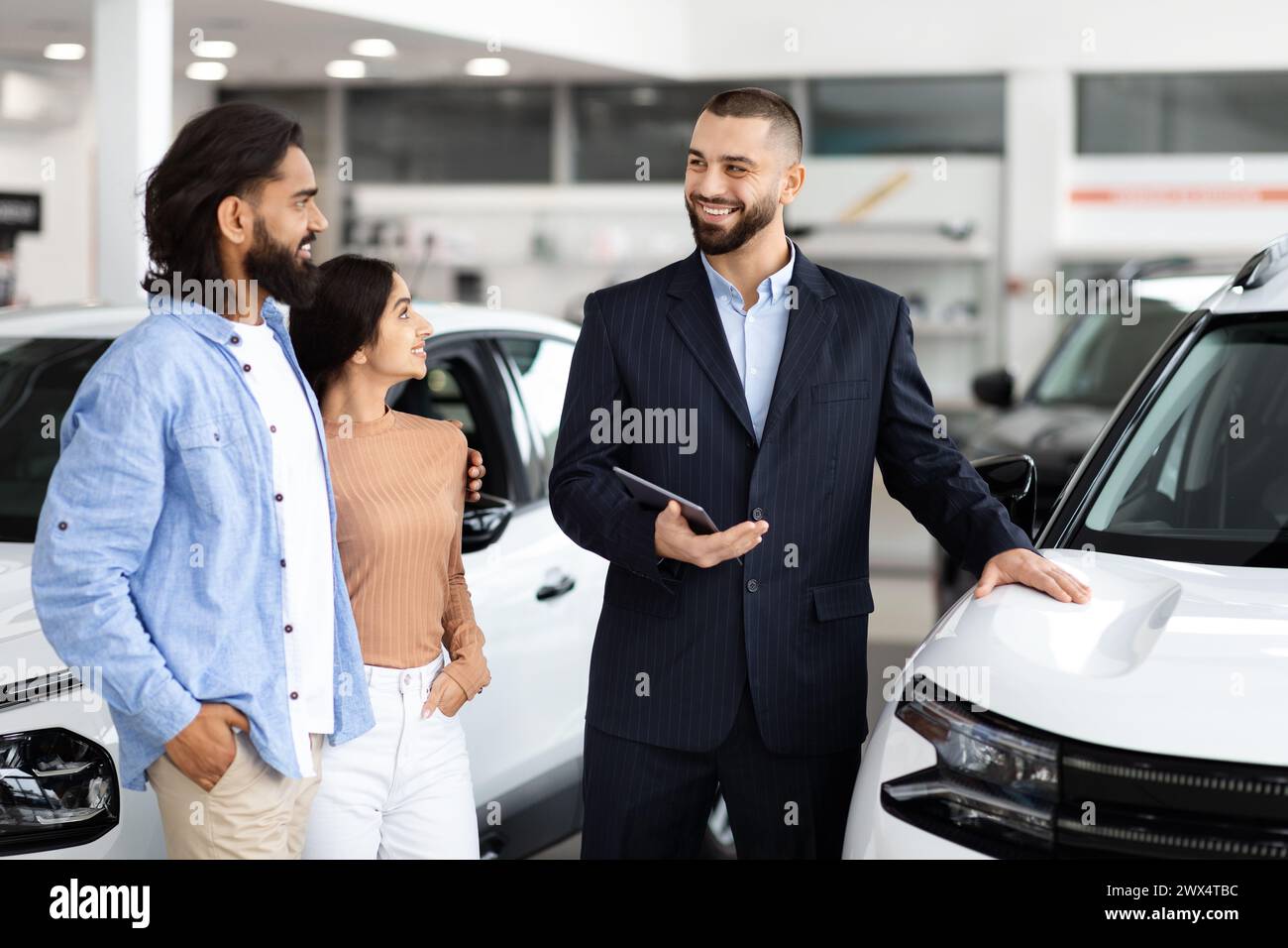 Car dealership interaction with salesman and customers Stock Photo - Alamy