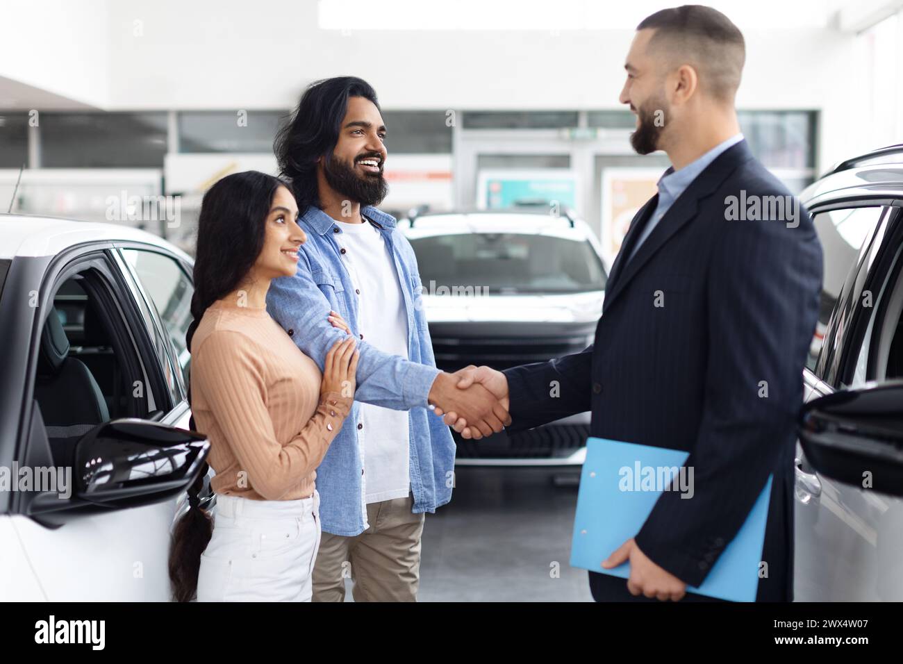 Indian couple buying a new car from salesman Stock Photo - Alamy
