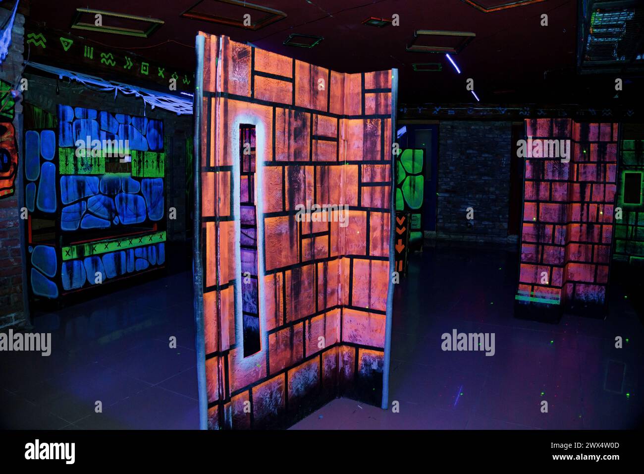 Labyrinth in neon light. Laser tag, paintball in a labyrinth with multi ...