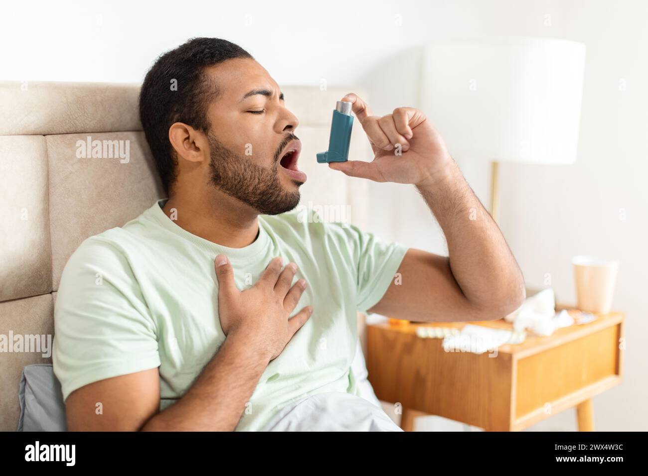 Man using inhaler during asthma attack Stock Photo - Alamy