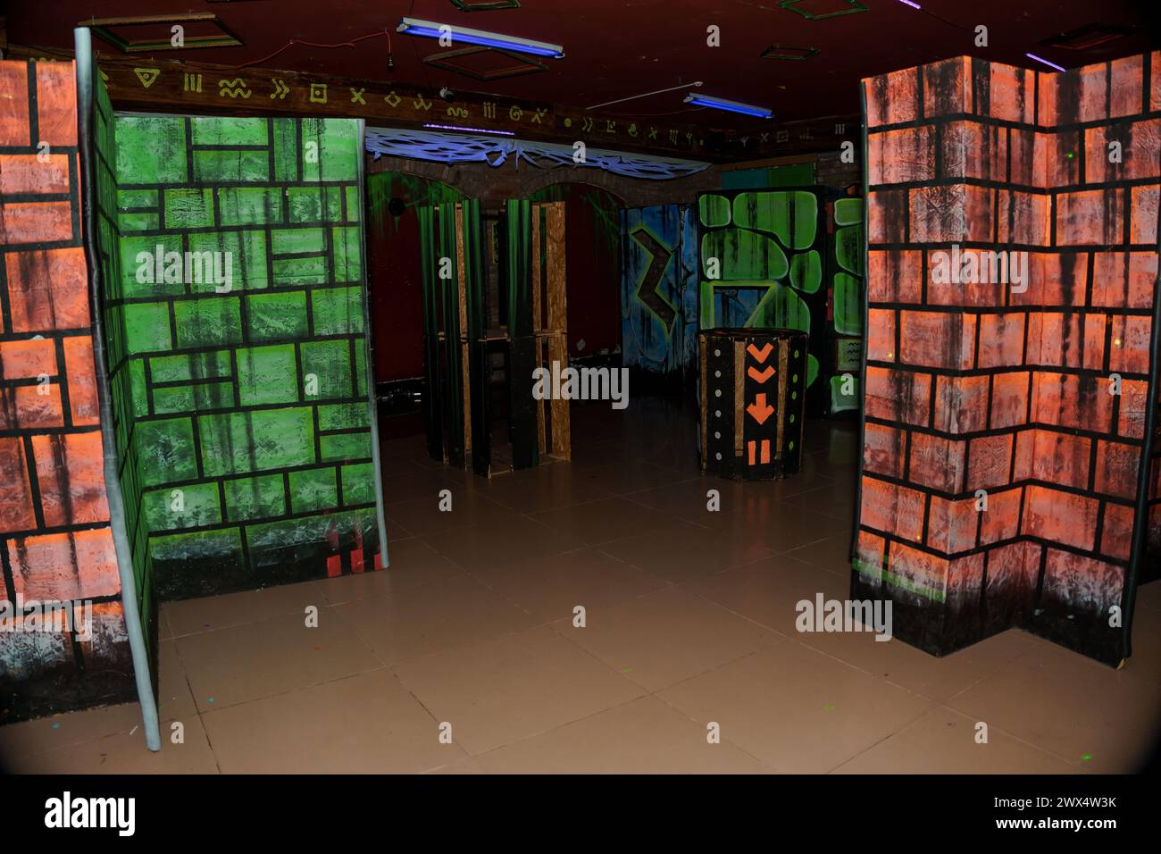 Labyrinth in neon light. Laser tag, paintball in a labyrinth with multi ...
