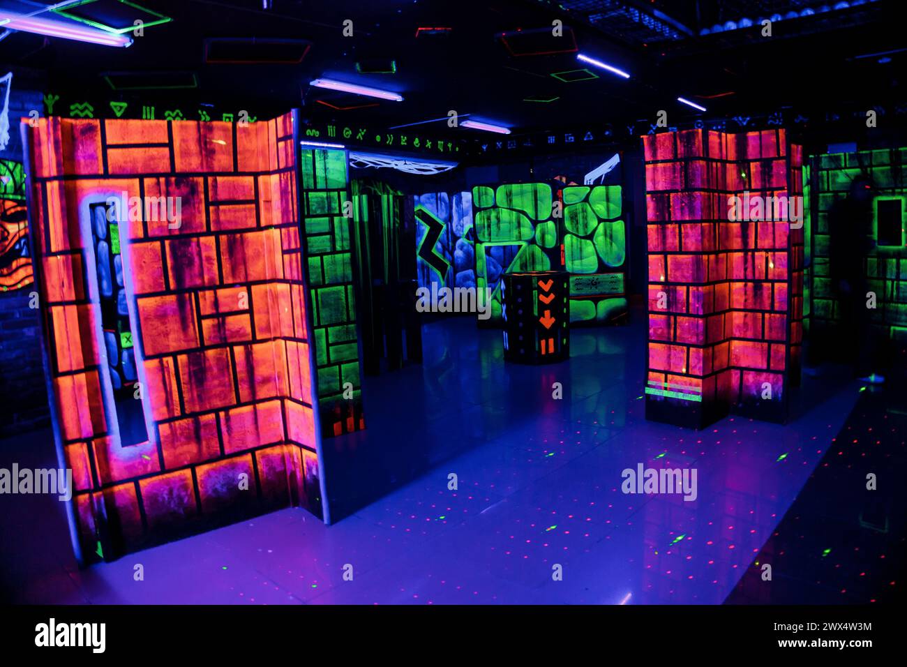 Labyrinth in neon light. Laser tag, paintball in a labyrinth with multi ...