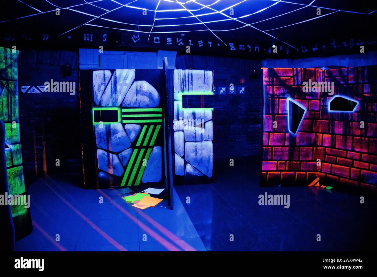 Labyrinth in neon light. Laser tag, paintball in a labyrinth with multi ...