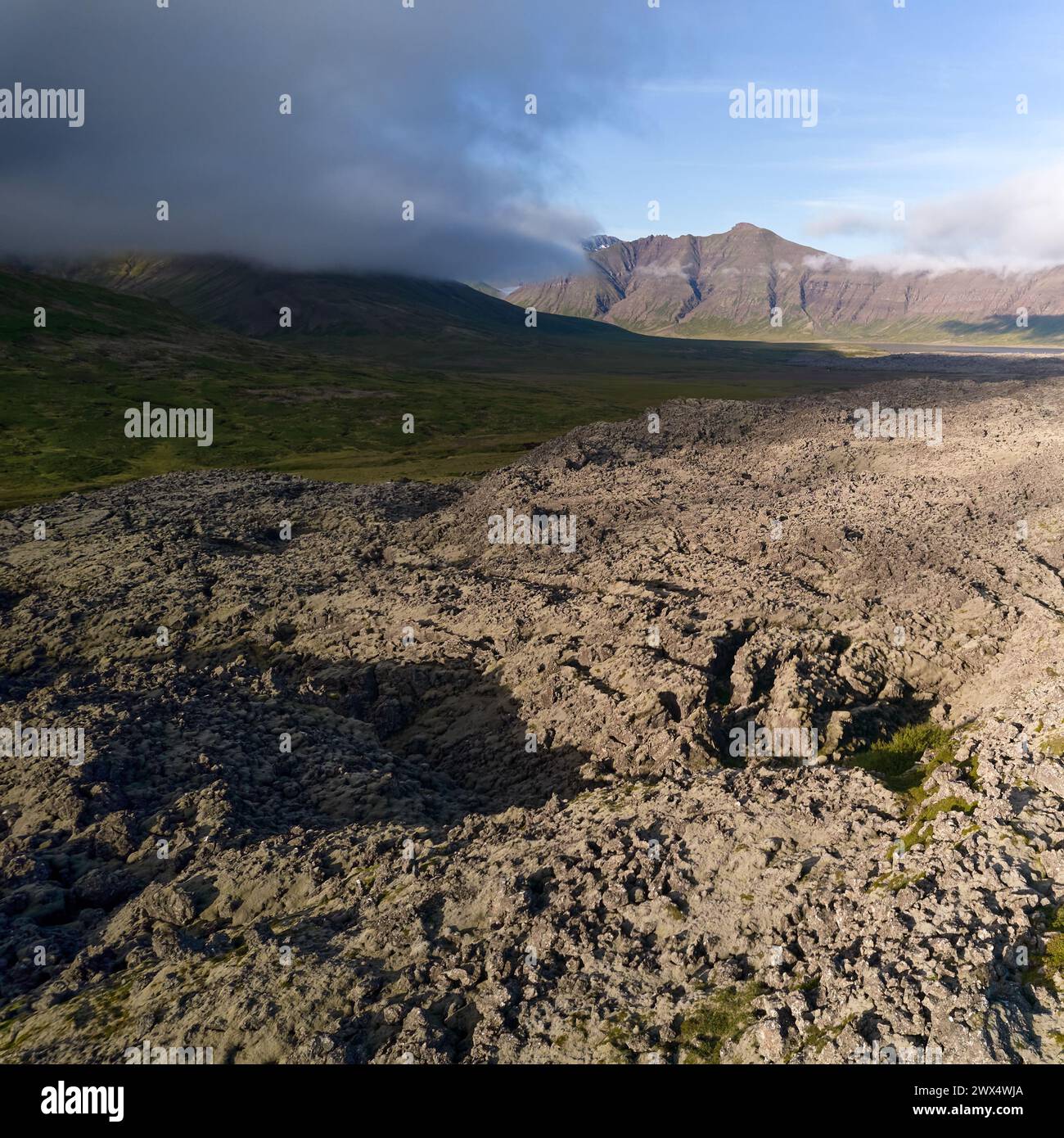 A view of the dirt road stretching to the horizon among the lava fields ...