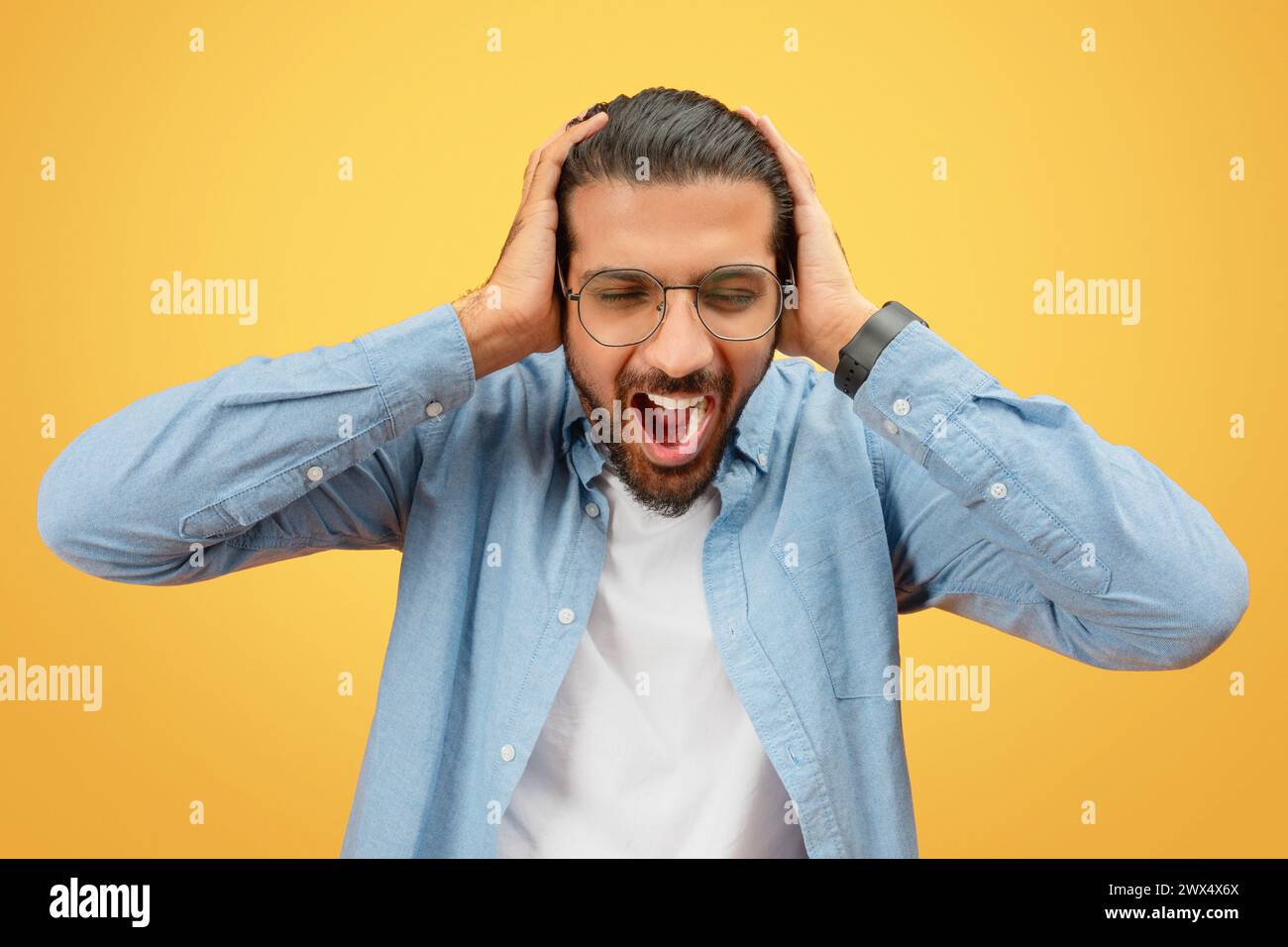 Desperate man holding head screaming Stock Photo - Alamy