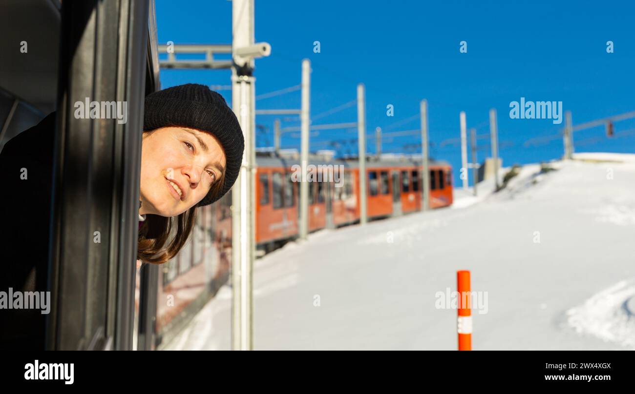 Woman traveler sticking head out of train window Stock Photo - Alamy
