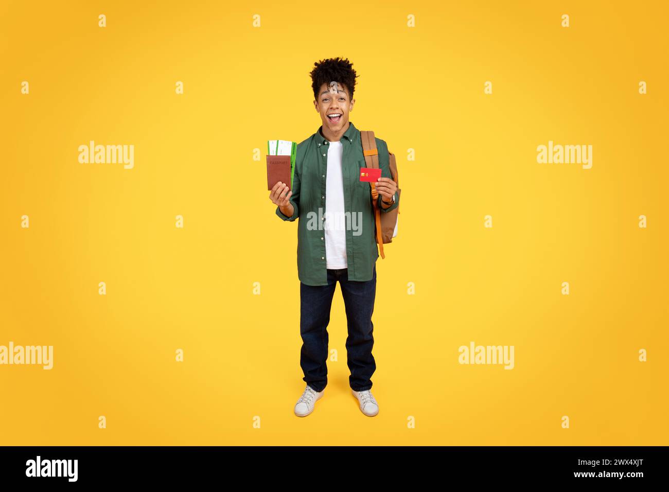 Happy young black guy traveler with passport and ticket Stock Photo - Alamy