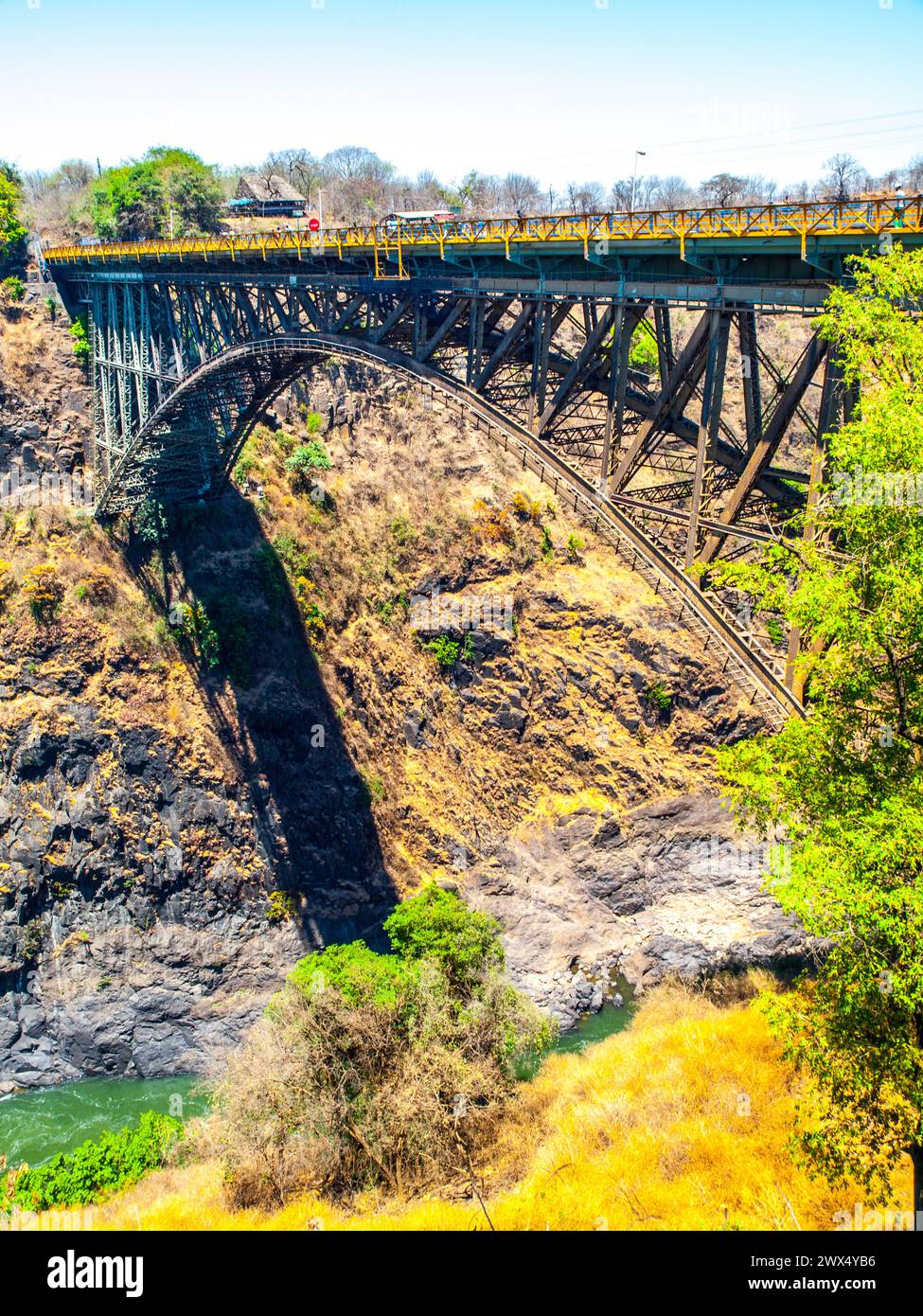 A view of the iconic Victoria Falls Bridge arching over the chasm with ...
