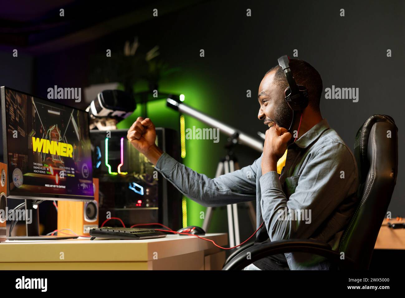 Cheerful gamer celebrating showing positive hi-res stock photography ...
