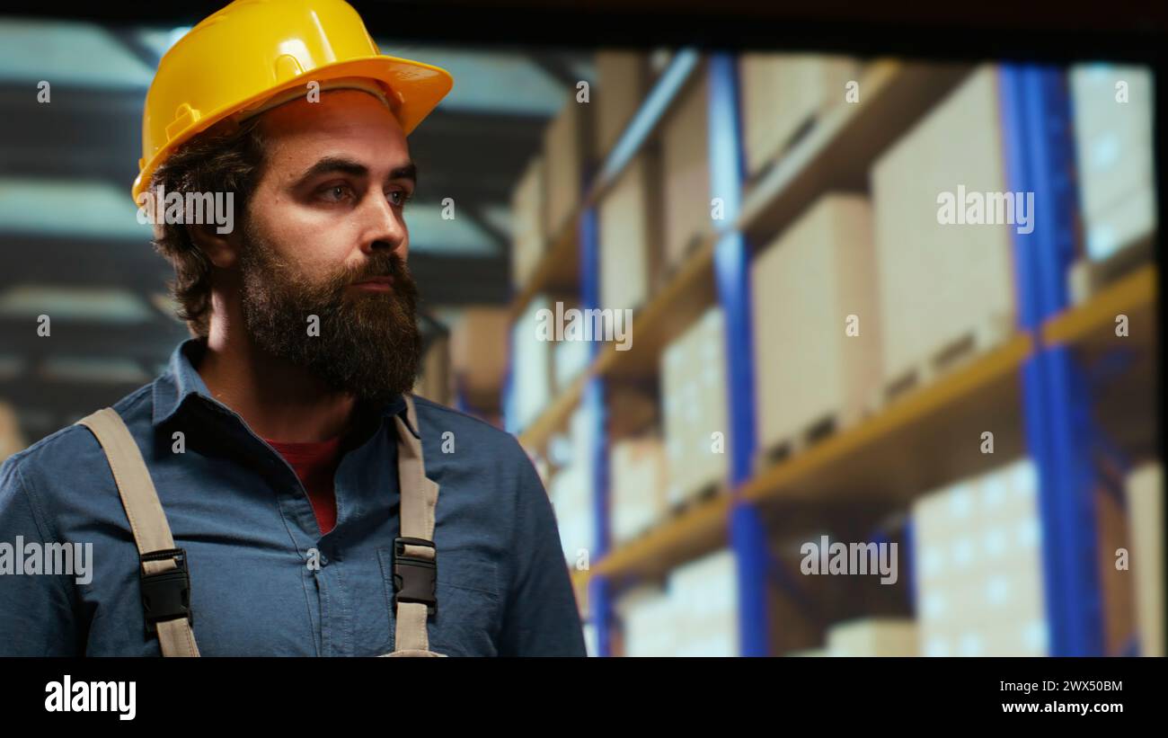 Packaging engineer examines merchandise stock in industrial depot ...