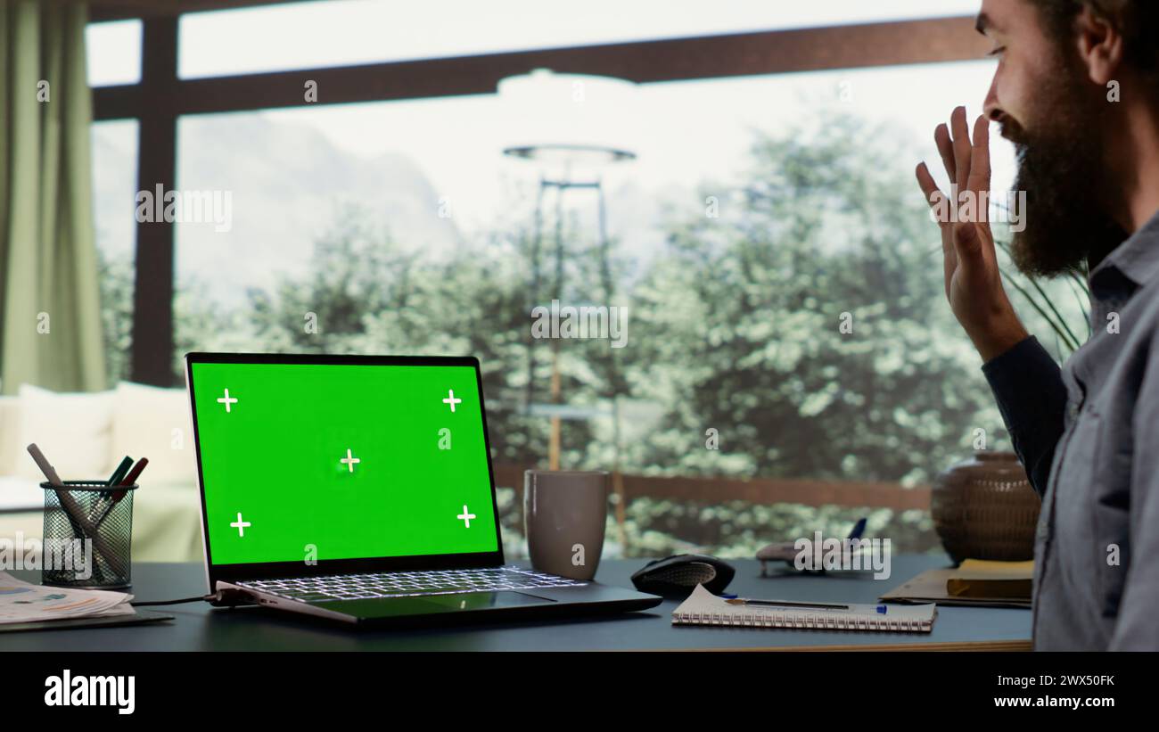 Rich businessman looks at greenscreen on pc, being cozy in his ...