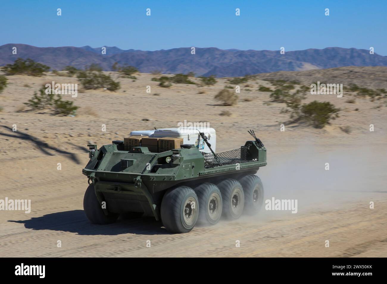 A Mission Master unmanned ground vehicle cruises through the desert as ...
