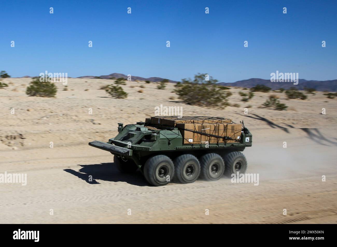 A Mission Master unmanned ground vehicle cruises through the desert as ...