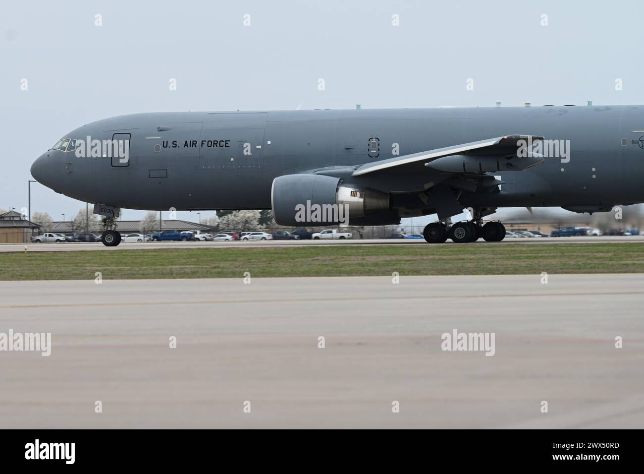 A KC-46A Pegasus with Wing Aerial Refueling Pods attached taxis on a ...