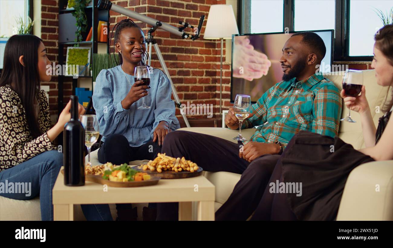 African american woman captivating friends at apartment party with ...