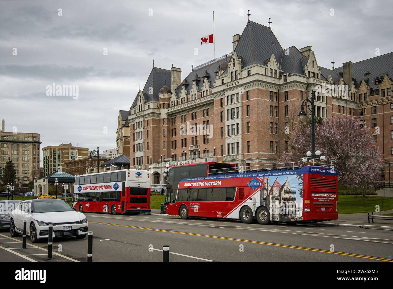 Photo of bright red sightseeing tour buses parked outside the historic ...