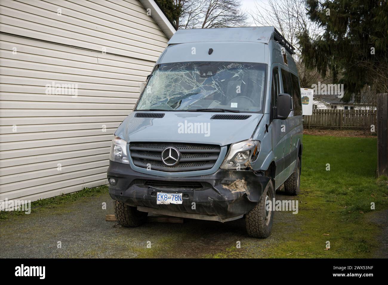 Photo of light blue VW camper van with smashed windshield and bumper ...