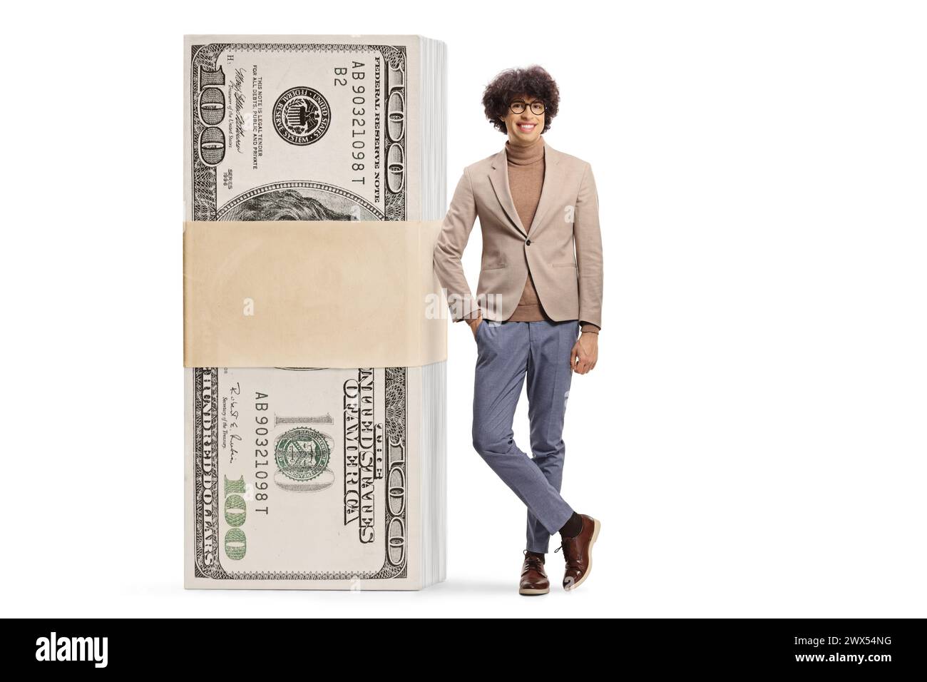 Young man leaning on a stack of money and smiling isolated on white ...