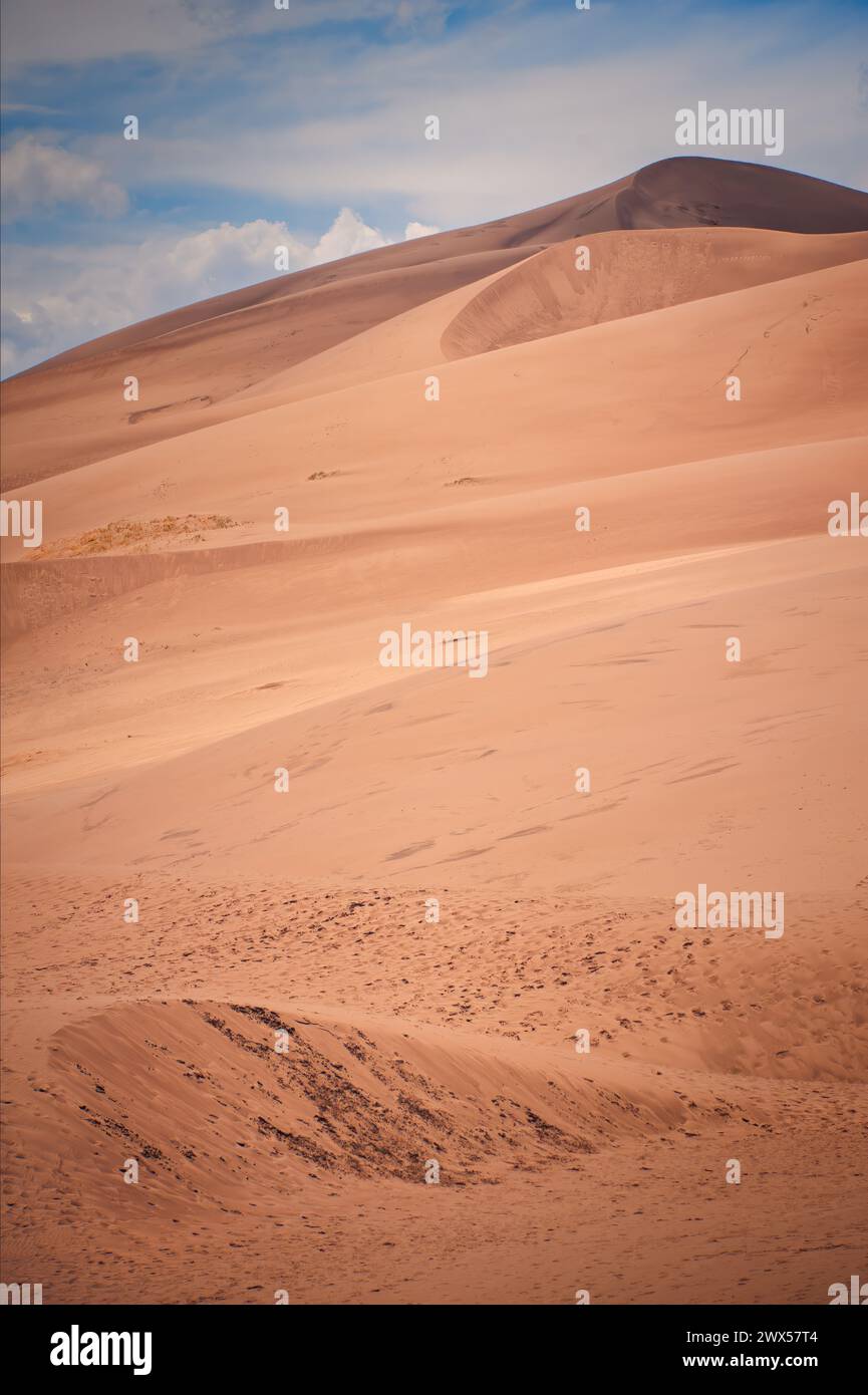 Vast sandy dunes stretch across the image, highlighted by the subtle ...