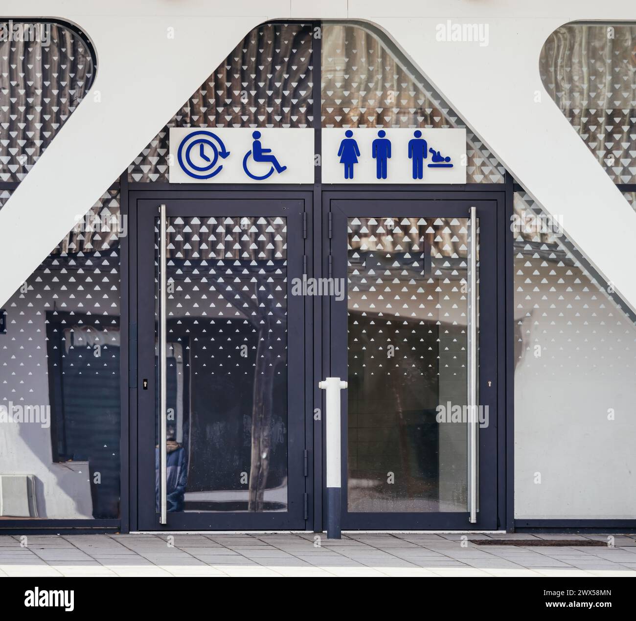 The entrance to the public toilet site features multiple pictograms ...