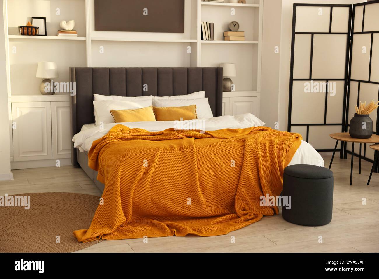 Bright plaid on bed in stylish bedroom. Interior design Stock Photo - Alamy