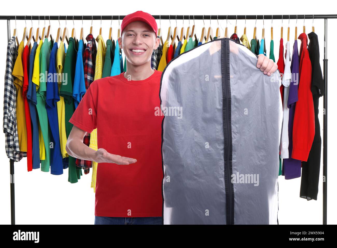 Dry-cleaning delivery. Happy courier holding garment cover with clothes ...