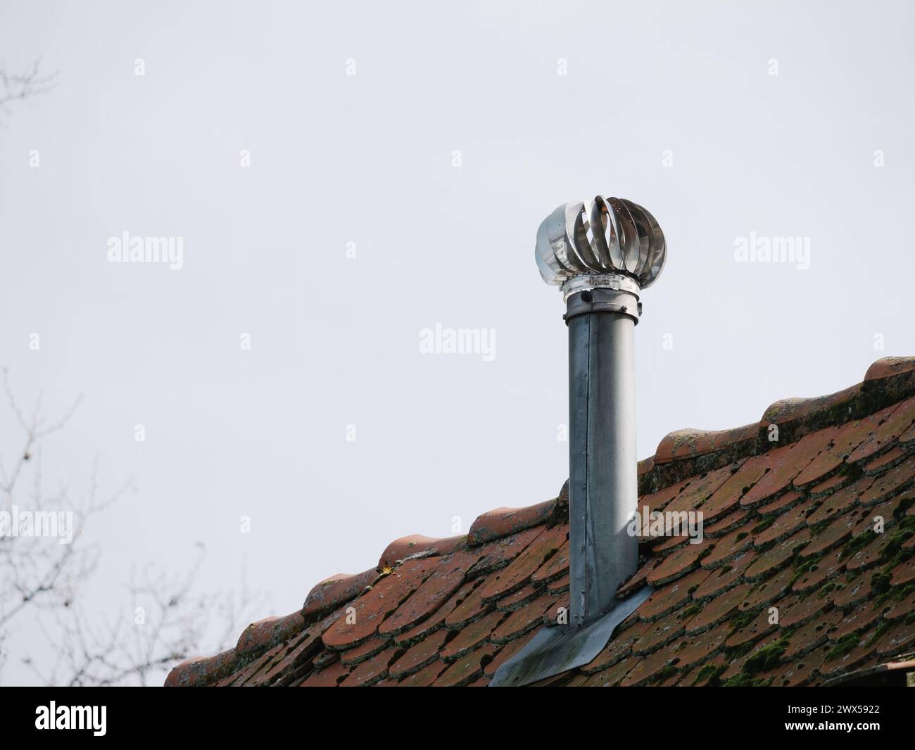 A weather vane positioned on top of a roof, indicating wind direction ...