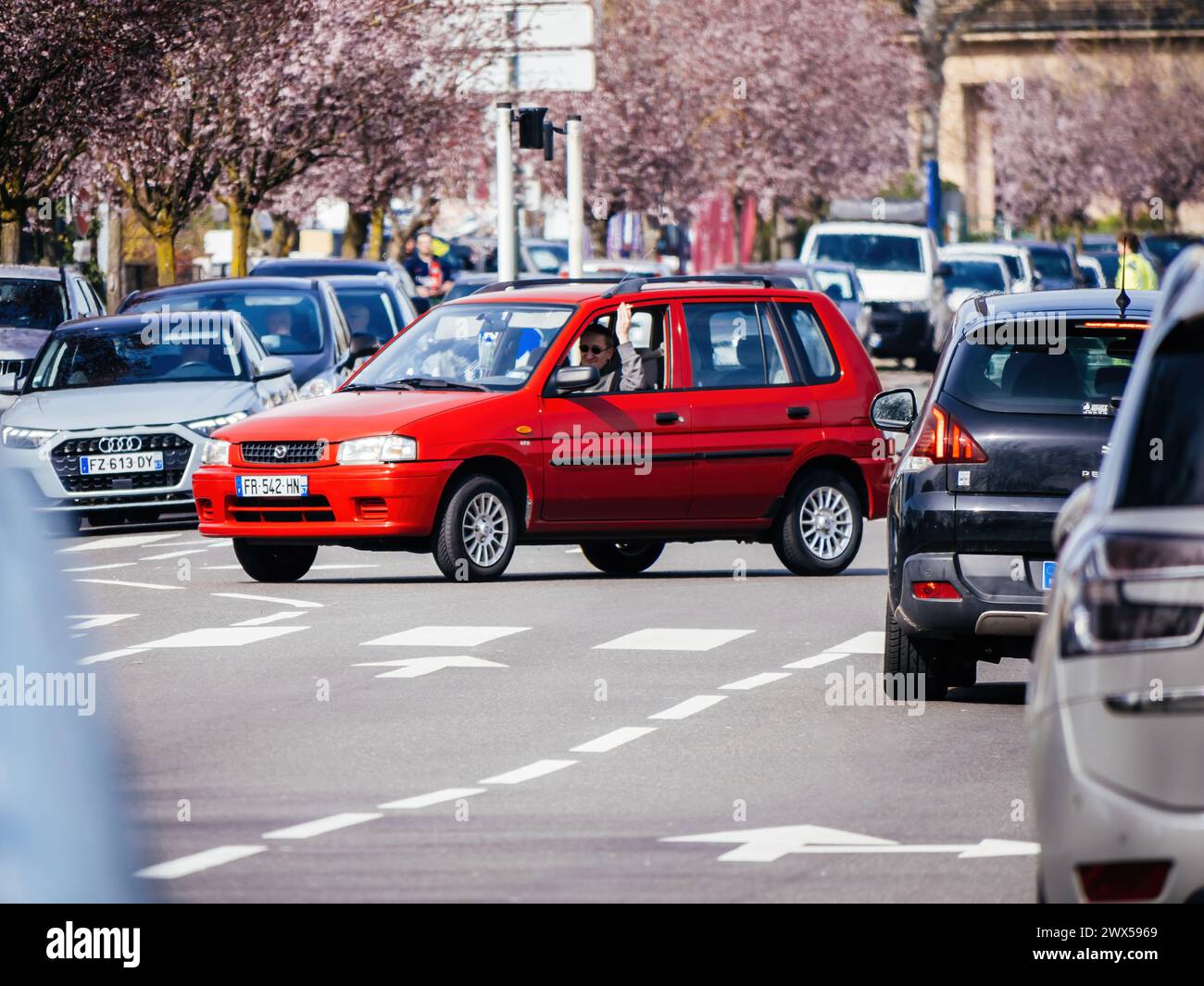 Haguenau, France - Mar 20, 2024: Red Peugeot car navigating through ...