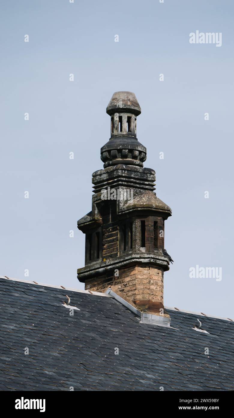 A detailed stone chimney adorns a rooftop in Haguenau, Alsace ...