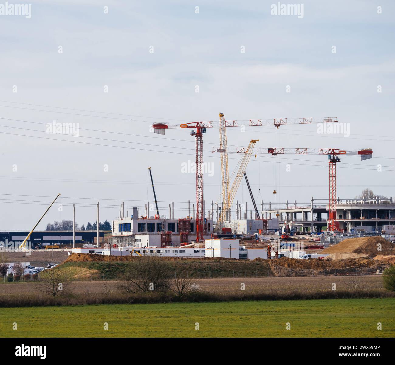 A view of a bustling construction site with multiple cranes in the ...