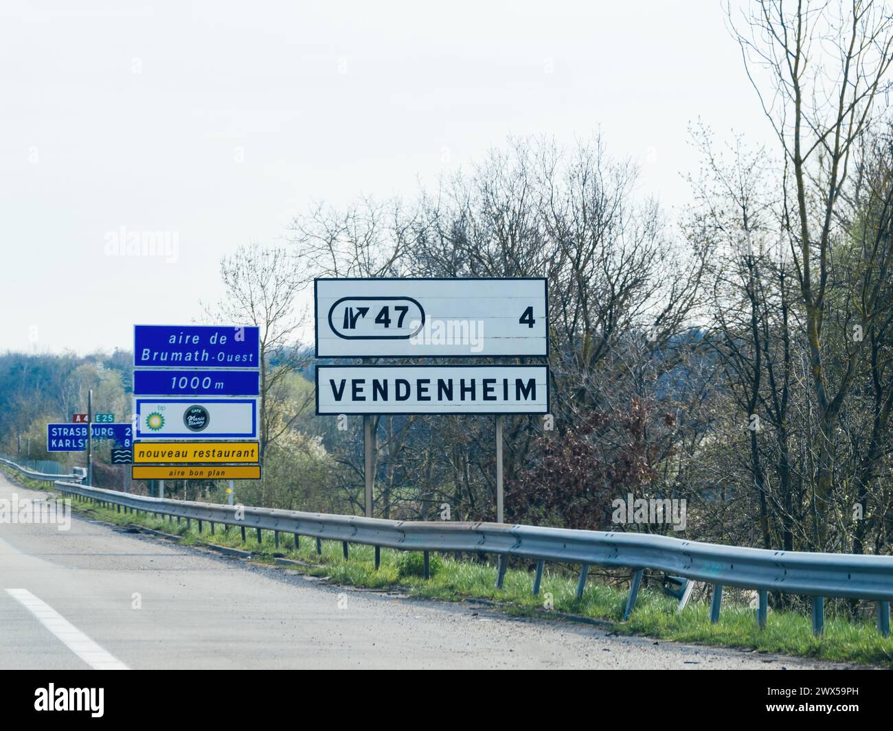Highway signage directs to Brumath Ouest and Vendenheim in France, with ...