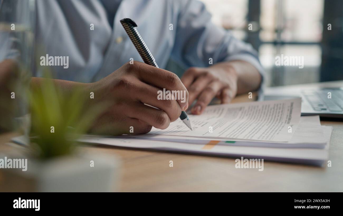 Close up unrecognizable man businessman writing paperwork report on ...