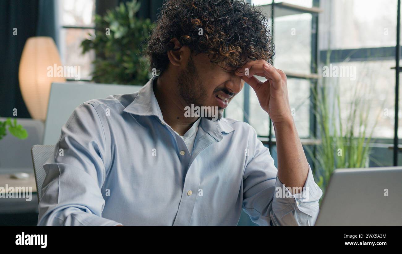 Tired Arabian Indian man sick businessman feel pain eyestrain ache male ...