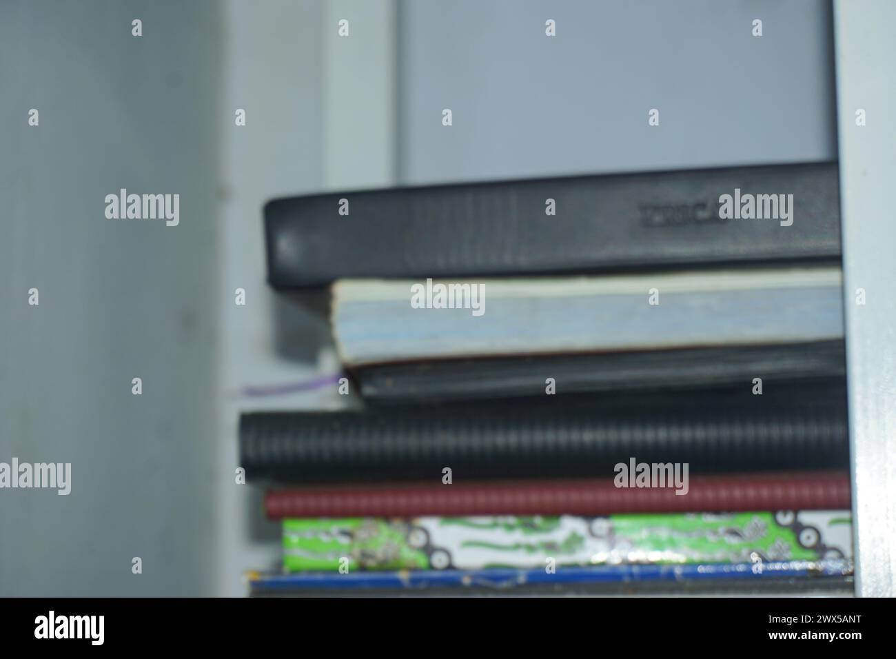 Photo of several books being opened and stacked on a reading shelf ...