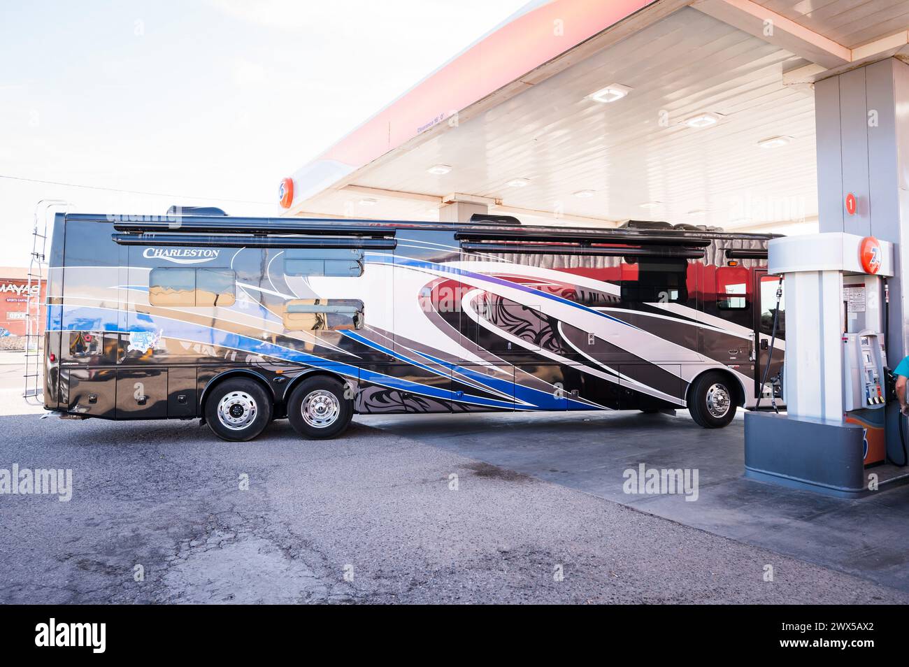 A large RV bus pulls into a gas station in Quartzite, Arizona, USA ...