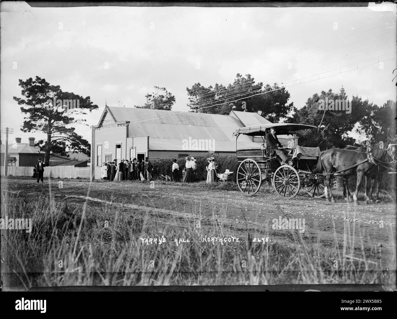 View of Queen Street showing a crowd gathered outside Tarry's Hall ...
