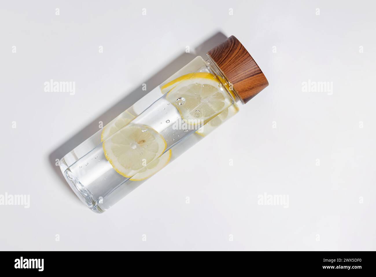 Stylish reusable bottle with lemon infused water isolated on white ...