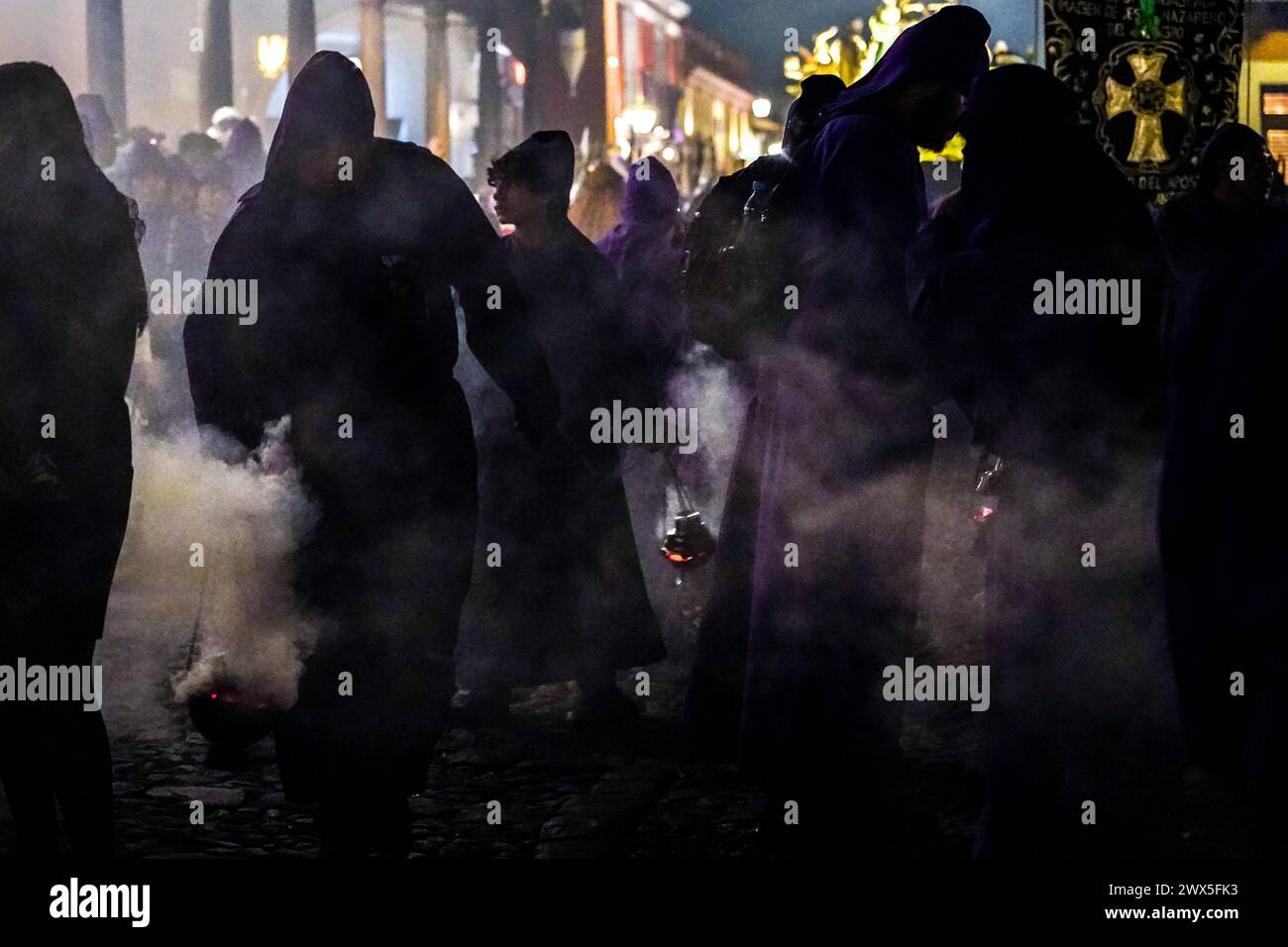 Antigua, Guatemala. 27th Mar, 2024. Penitents use censers to spread ...