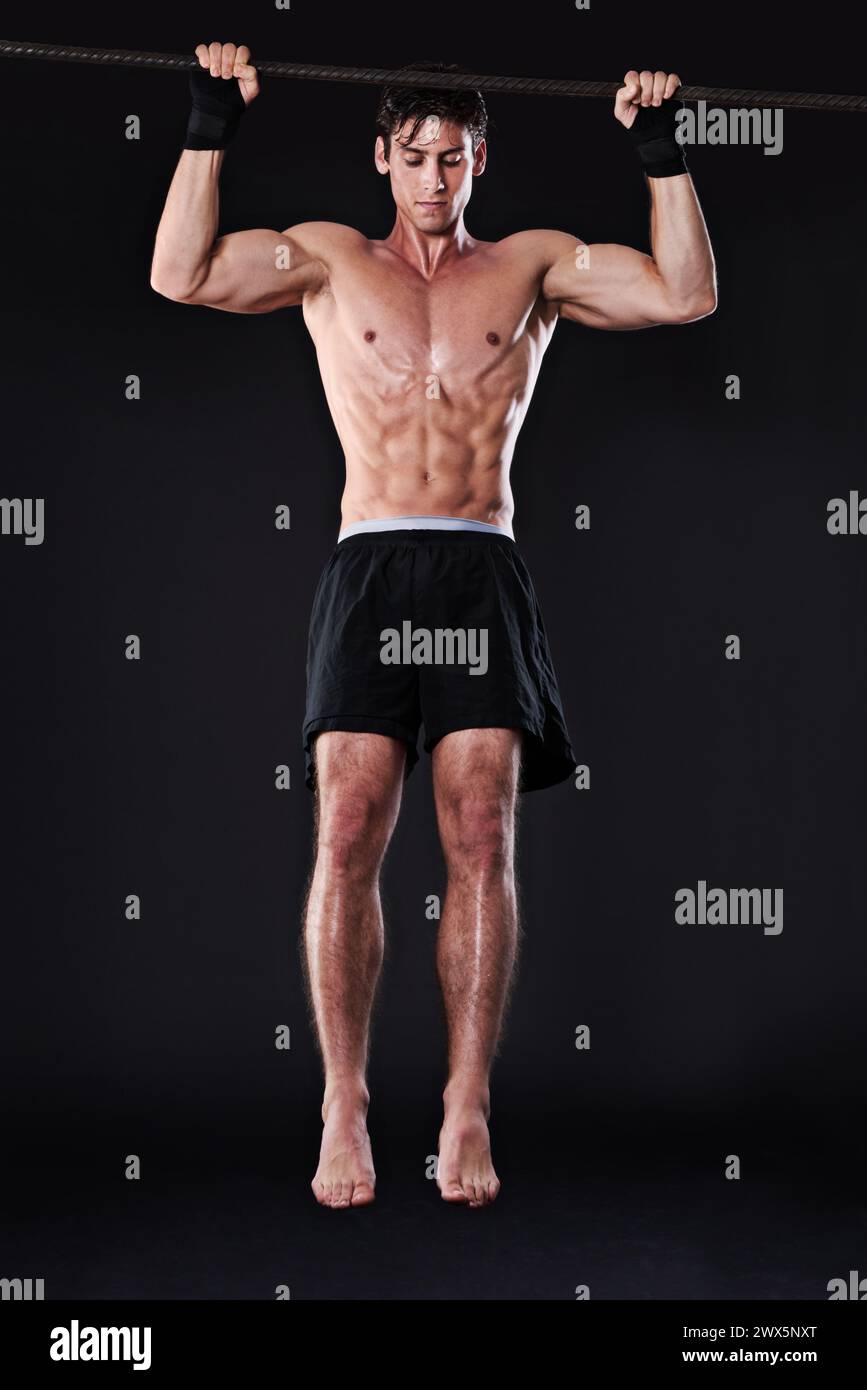 Man, pull up and arm exercise in studio for bicep training or muscle ...