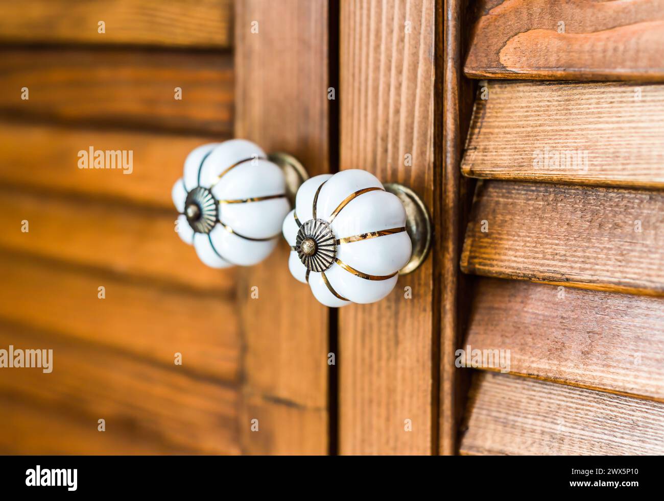two wooden door handles close up Stock Photo - Alamy