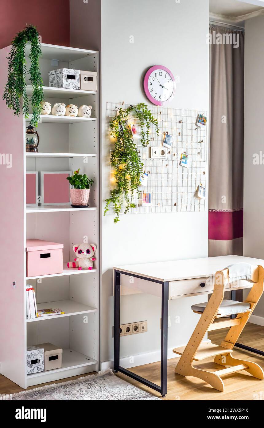 desk and wardrobe for children's room in white and pink colors without ...
