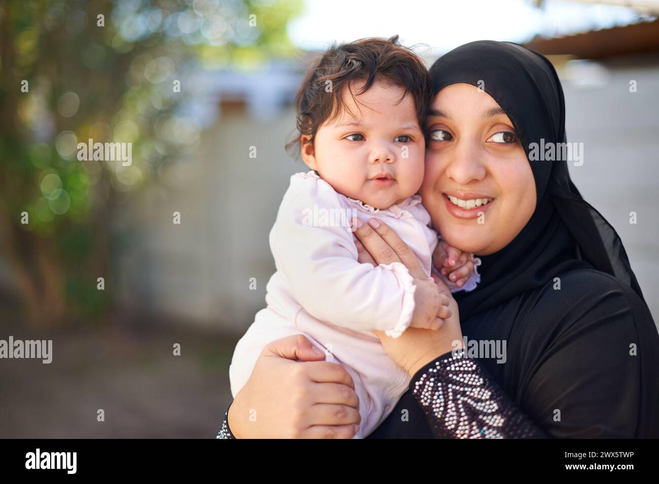 Muslim, woman and baby hug outdoor, happy in garden with mother and ...