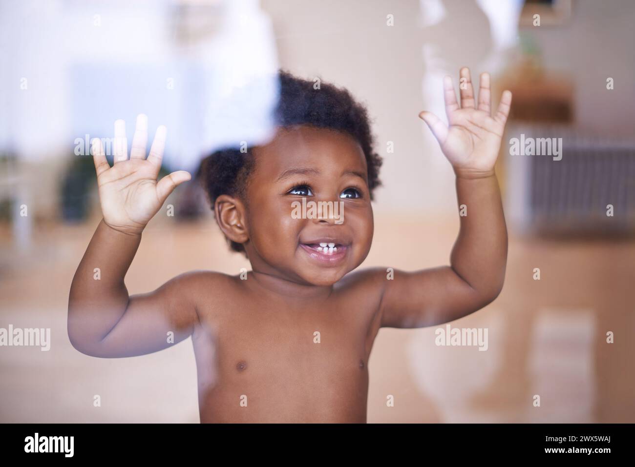 Baby, happy and smile behind window, natural and child development for ...