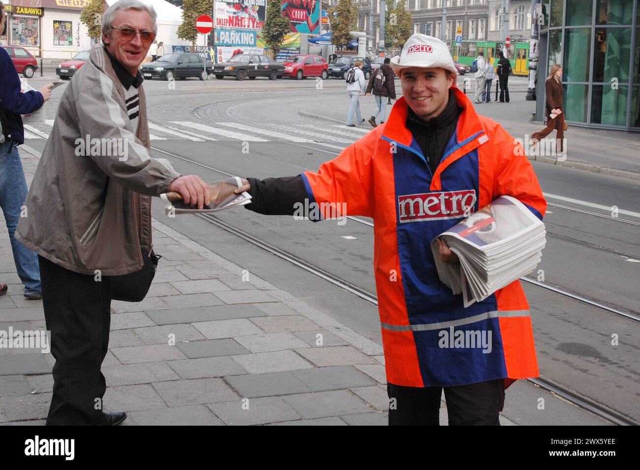 polish man distributing free Poznan Free Metro paper in Poznan Poaldn ...