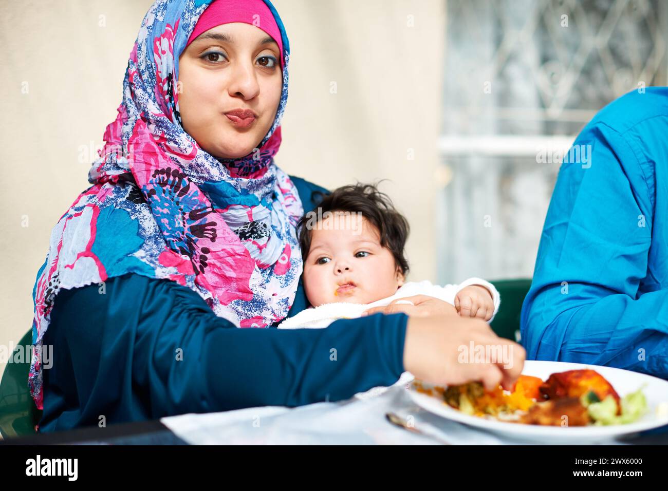 Mom, baby and muslim in table for dinner with food for eid, ramadan and religion to enjoy at ...