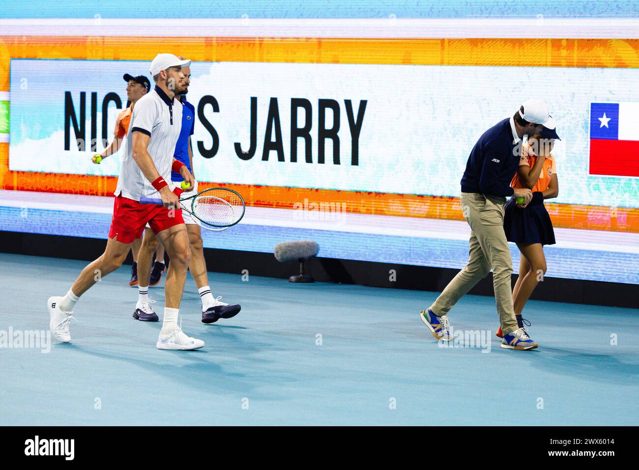 MIAMI GARDENS, FLORIDA - MARCH 27: Nicolas Jarry of Chile checks on ...