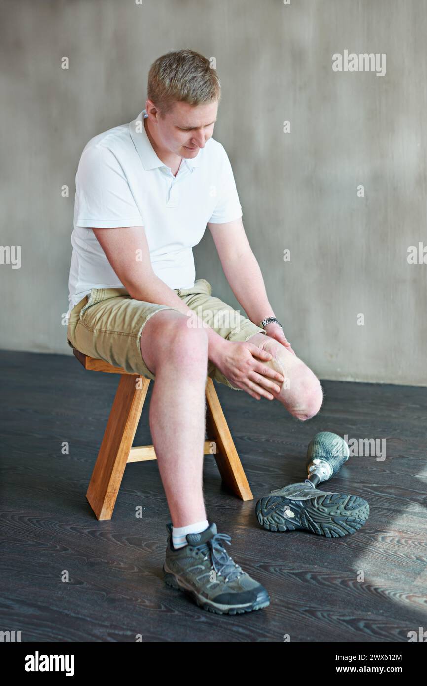 Dressing, amputee and prosthetic leg and man in gym sitting, residual ...